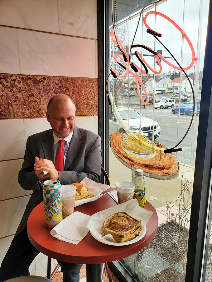 Even men in suits can't resist the simple pleasure of a perfect sandwich. This window seat at Carmen's offers both sustenance and street theater.