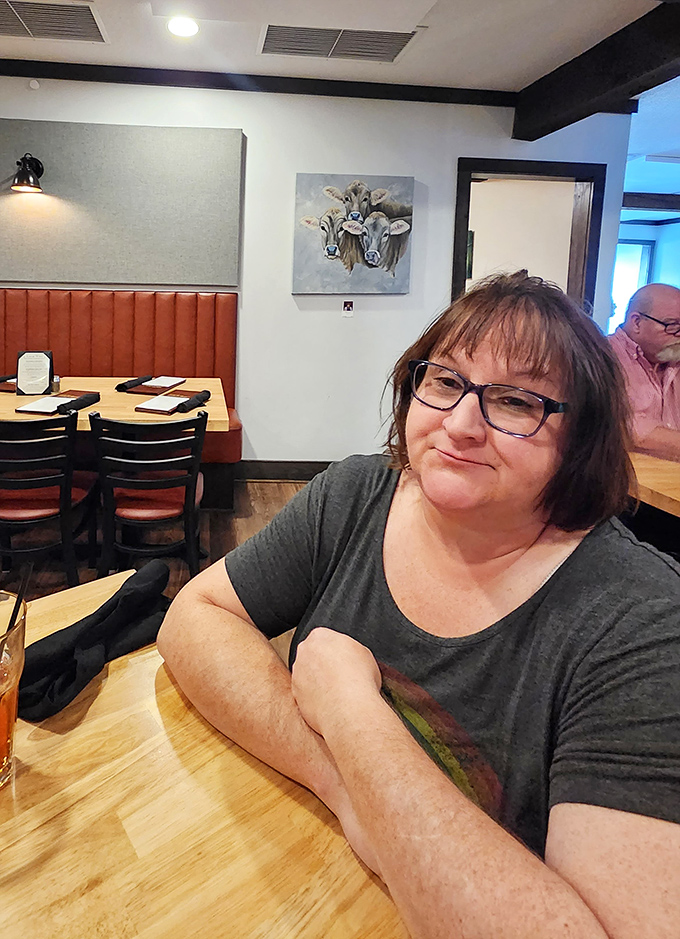 Comfortable seating and cow artwork create the perfect dining atmosphere. Every table feels like you've scored the best seat in the house.