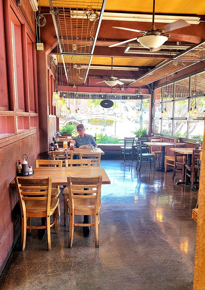 Diners bathed in natural light, surrounded by warm wood tones. That peaceful look on faces? That's the universal expression for "barbecue satisfaction."