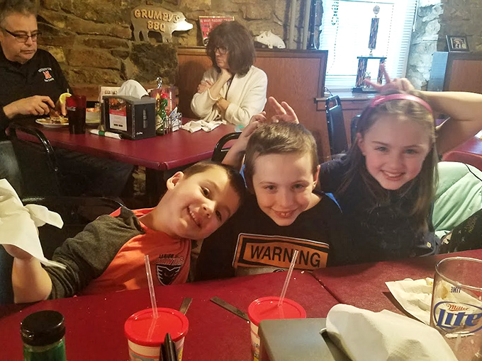 Family dining at its finest—where memories are made between bites of barbecue and children learn the sacred art of appreciating slow-cooked perfection.