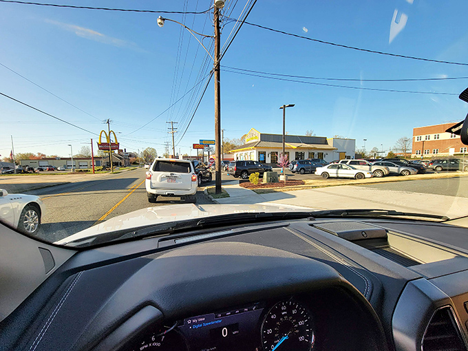 The drive-thru view reveals Biscuitville's prime real estate in the breakfast ecosystem, where morning hunger is satisfied without fancy pretense.