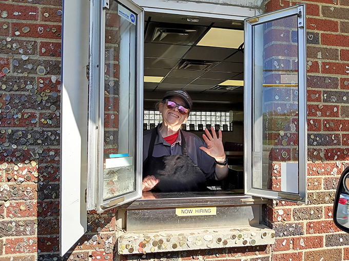 Service with a smile! The drive-thru window offers the same warm welcome as inside, with the added bonus of that famous gum wall. 