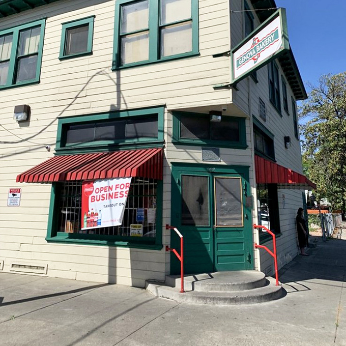 The entrance says "neighborhood joint," but the reputation says "destination." Those red railings have supported generations of sandwich enthusiasts.