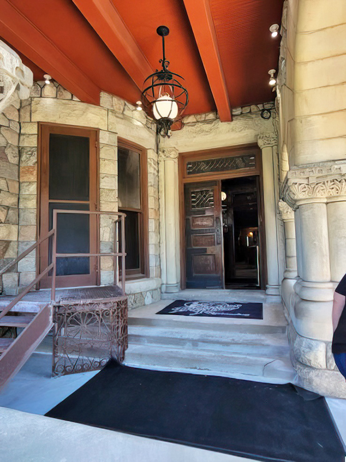 The entrance beckons with stone columns and carved details, like a portal to an era when craftsmanship wasn't optional and neither was formal dinner attire.