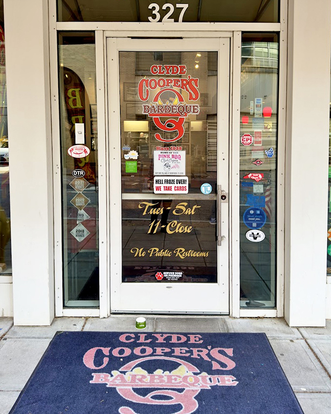 "Hell froze over! We take cards!" proclaims the door to pork paradise. This entrance has welcomed barbecue pilgrims from across the country, all drawn by smoke and reputation.