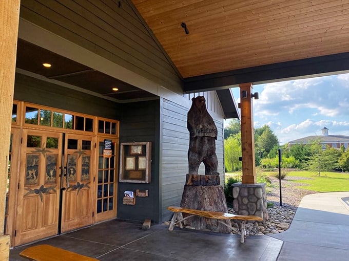 The entrance features a carved bear standing sentinel. It's not just decoration&mdash;it's a promise of the wild experience waiting inside.