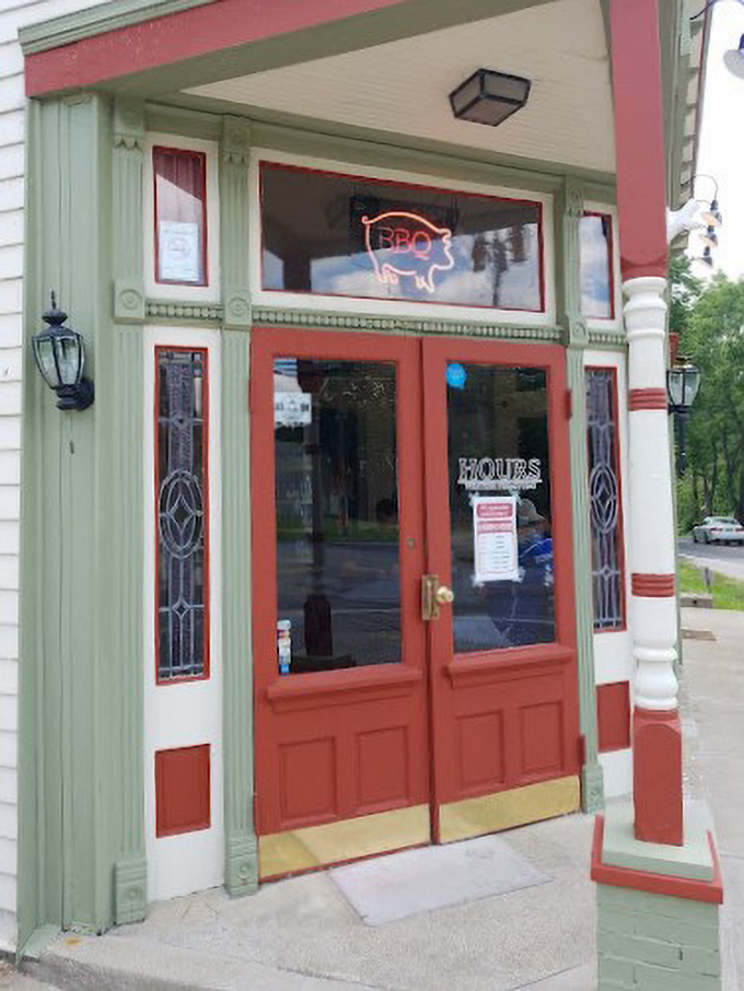 This charming entrance to what appears to be their original location has the quaint appeal of a BBQ joint with history. The neon pig says it all.