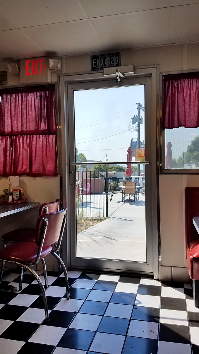 Even the exit view promises you'll be back&mdash;red curtains framing the doorway like the final act of a delicious performance.