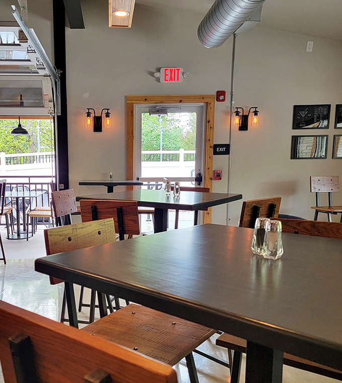 Industrial-chic lighting fixtures cast a warm glow over wooden tables, creating the perfect backdrop for food that deserves your full attention.