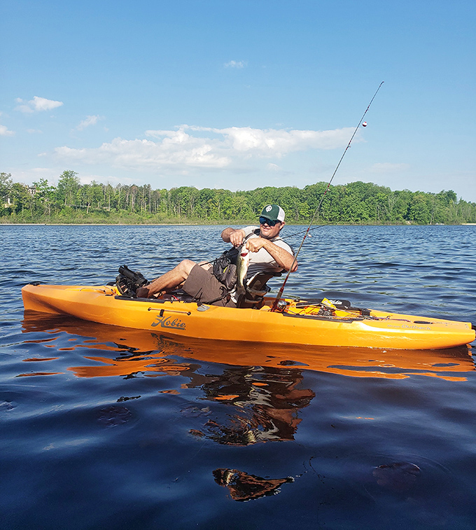 Fishing from a kayak&mdash;combining two great outdoor activities into one perfect package. That smile says "dinner's on me tonight!"