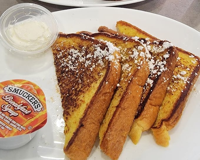 French toast dusted with powdered sugar like the first delicate snowfall of winter. Each golden triangle promises a sweet escape from ordinary breakfast.