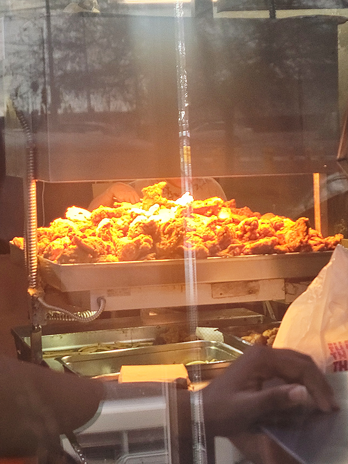 Behold the mountain of freshly fried chicken, a golden-brown monument to crispy perfection.