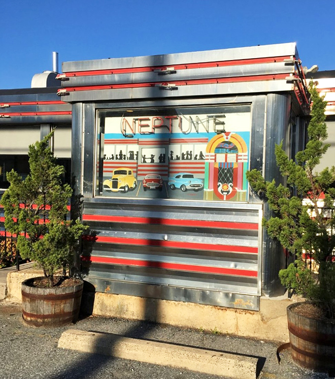 Neptune's entrance, flanked by barrel planters, invites you into a world where calories don't count and coffee refills flow like conversation.