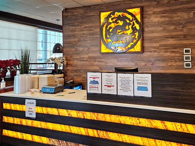 The reception desk &ndash; your gateway to gluttony. That amber-lit dragon logo isn't just decoration; it's a warning of the fire your taste buds are about to experience.