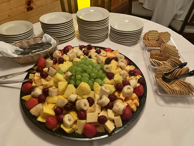 A fruit and cheese platter that's basically a party on a plate. The grapes in the center are like the host making sure everyone mingles properly.
