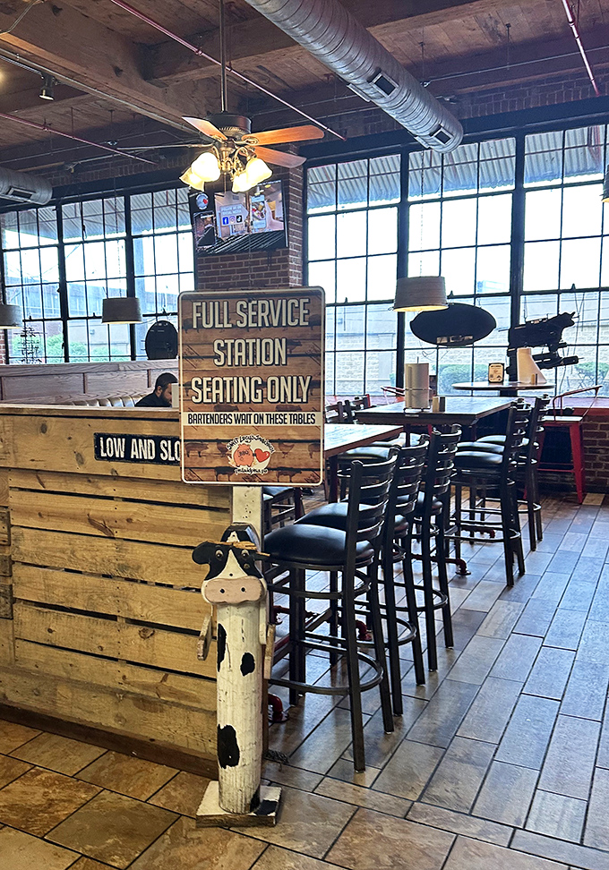 "Full Service Station" seating area combines industrial charm with BBQ functionality&mdash;where serious meat consumption is treated with proper respect.