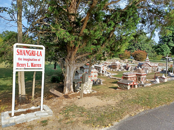 The entrance sign reveals this wonderland as "the imagination of Henry L. Warren." Some people build model trains; Warren built an entire stone civilization.