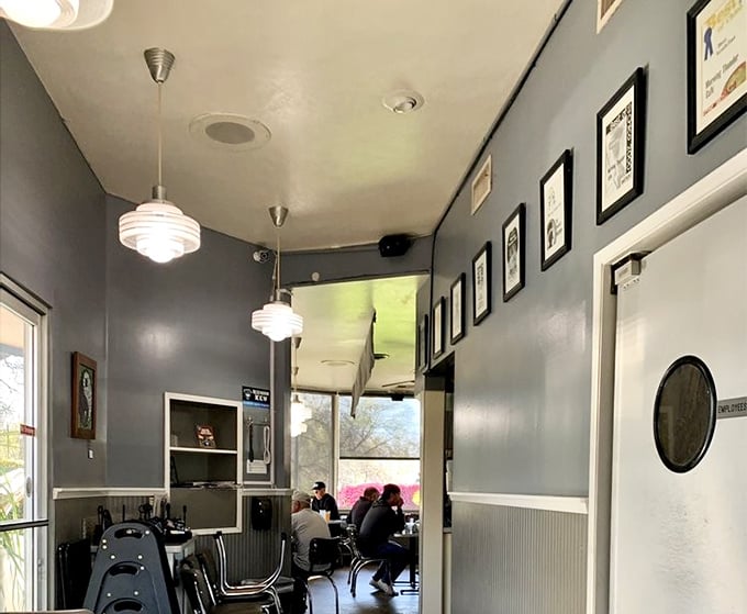Gray walls adorned with framed memories lead diners through a hallway that might as well be labeled "Path to Satisfaction."
