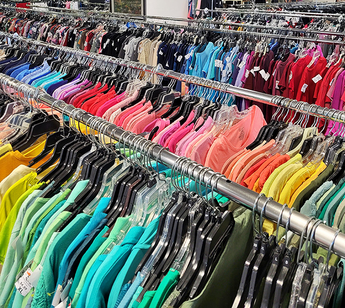 The rainbow of possibilities! Color-coordinated clothing racks transform secondhand shopping into an organized art form rather than chaotic rummaging.