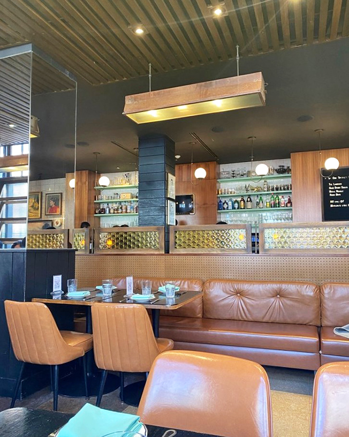 The bar area whispers of cocktail hour conversations yet to come, with leather banquettes practically begging you to settle in for the evening.