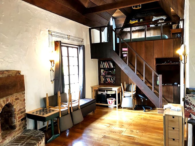 Inside reveals the same charm as outside. Exposed beams and wooden floors create spaces where you half expect to find ancient tomes of forgotten knowledge on the shelves.