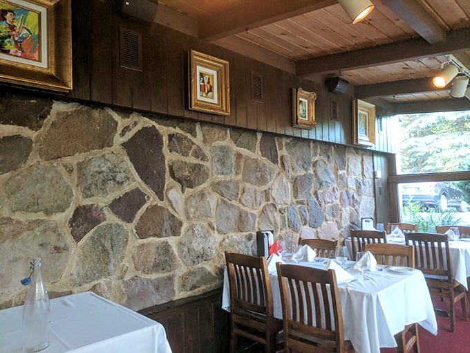 Stone walls meet wooden paneling in a dining room that feels like it's been perfecting the art of ambiance since before Instagram made food famous.