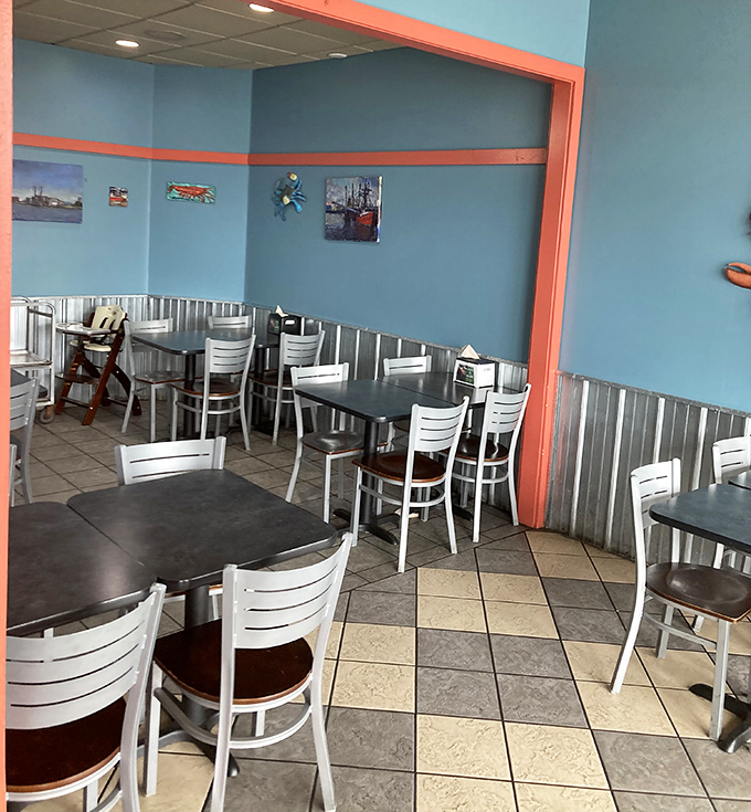Blue walls, white chairs, and corrugated metal wainscoting create a vibe that says, "We're serious about seafood, not d&eacute;cor."