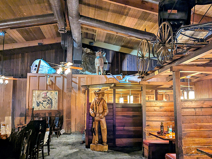 Western artifacts and wooden carvings create an atmosphere that's part museum, part dining adventure. That cowboy statue has seen some serious eating.