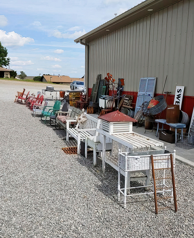 The outdoor overflow section proves one antique lover's "that won't fit in my house" is another's "perfect porch furniture." Those white benches have stories to tell.