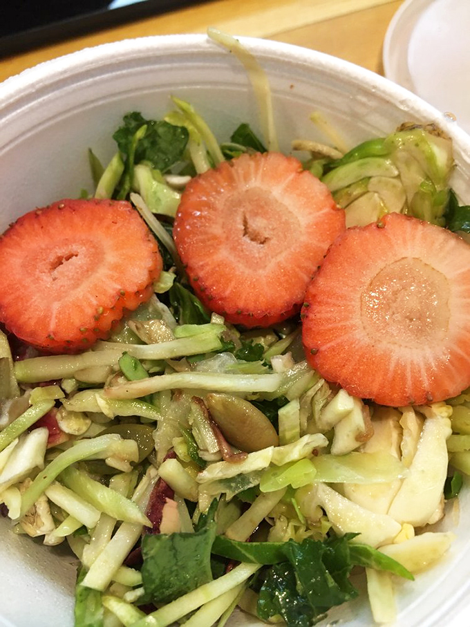 A strawberry kale salad that doesn't feel like punishment. This fresh, vibrant side proves BBQ joints understand balance&mdash;and that vegetables can be delicious too.