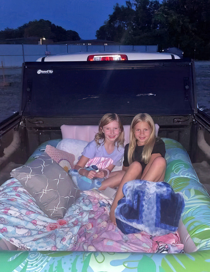 Pickup truck paradise for pint-sized viewers. These young moviegoers have the best seats in the house, complete with blanket fort potential.