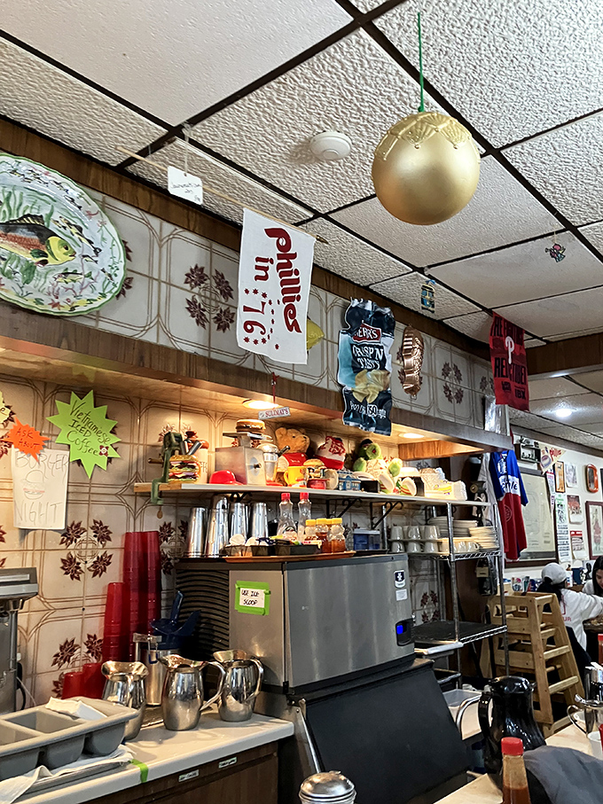 The kitchen area, where coffee flows freely and breakfast magic happens under the watchful eyes of Phillies pennants and decades of tradition.