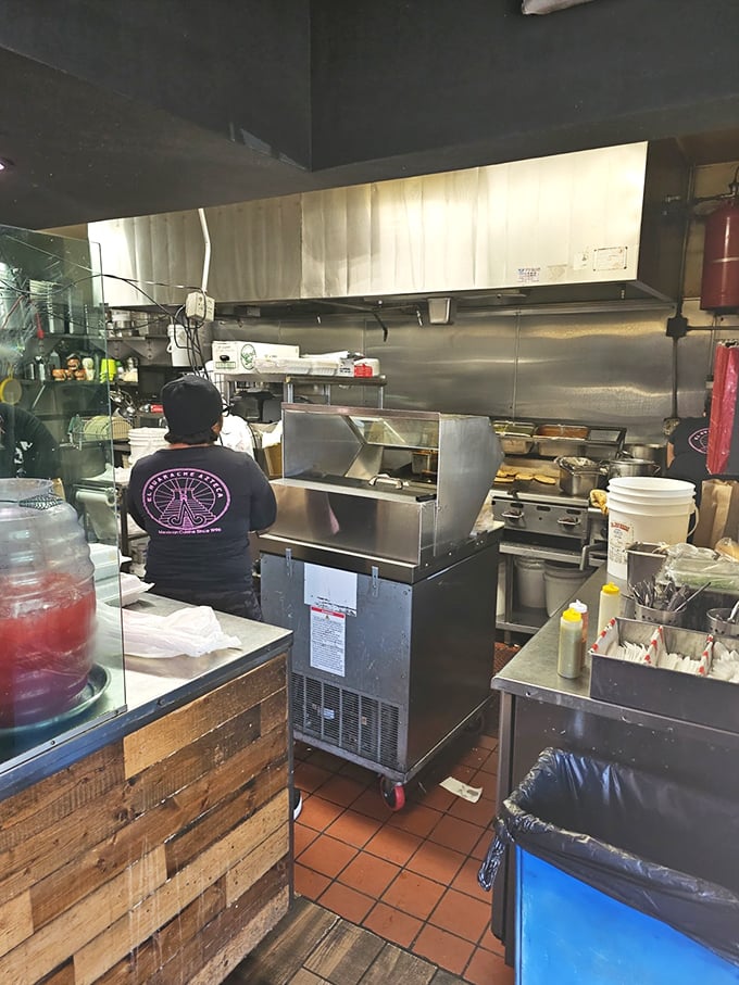 The kitchen's organized chaos reveals the serious business of creating food that tastes like someone's cherished memories.