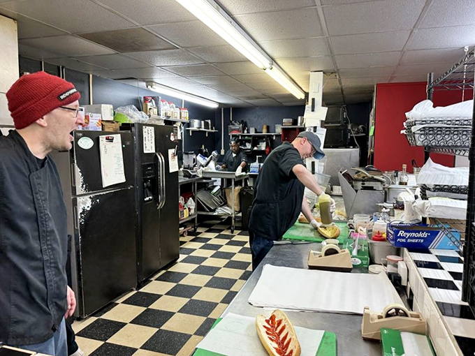 Behind the scenes magic where sandwich artists craft their masterpieces on a classic black and white checkered floor.