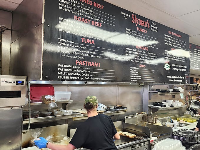 Behind the scenes where sandwich magic happens. The menu board looms overhead like the commandments of deliciousness that they are.