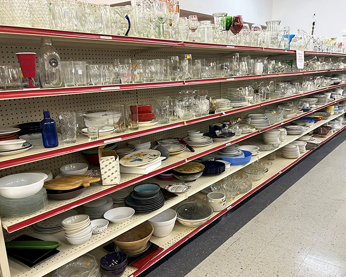 Glassware and dishes stacked like an archaeological dig through America's dining history. That blue bowl might have served countless Sunday dinners.
