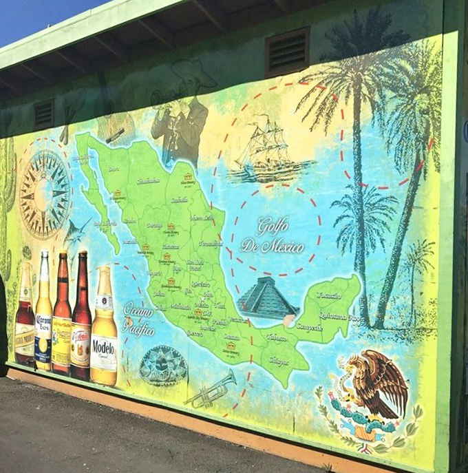 A vibrant mural celebrates Mexican heritage with geography, beer, and national pride. It's a vacation postcard you can enjoy without TSA pat-downs.