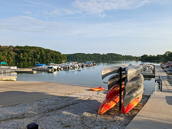 The marina stands ready for adventure, with boats and kayaks lined up like colorful candies in a store display of outdoor possibilities.
