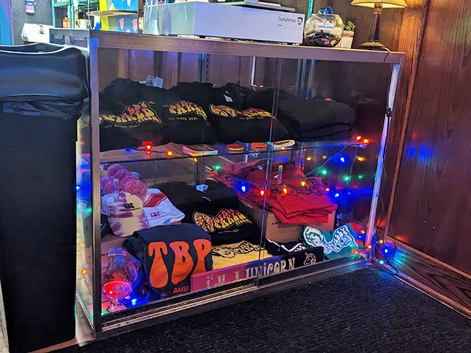 The merch display glows like a shrine to pizza worship—because when the food's this good, you want to wear the t-shirt.