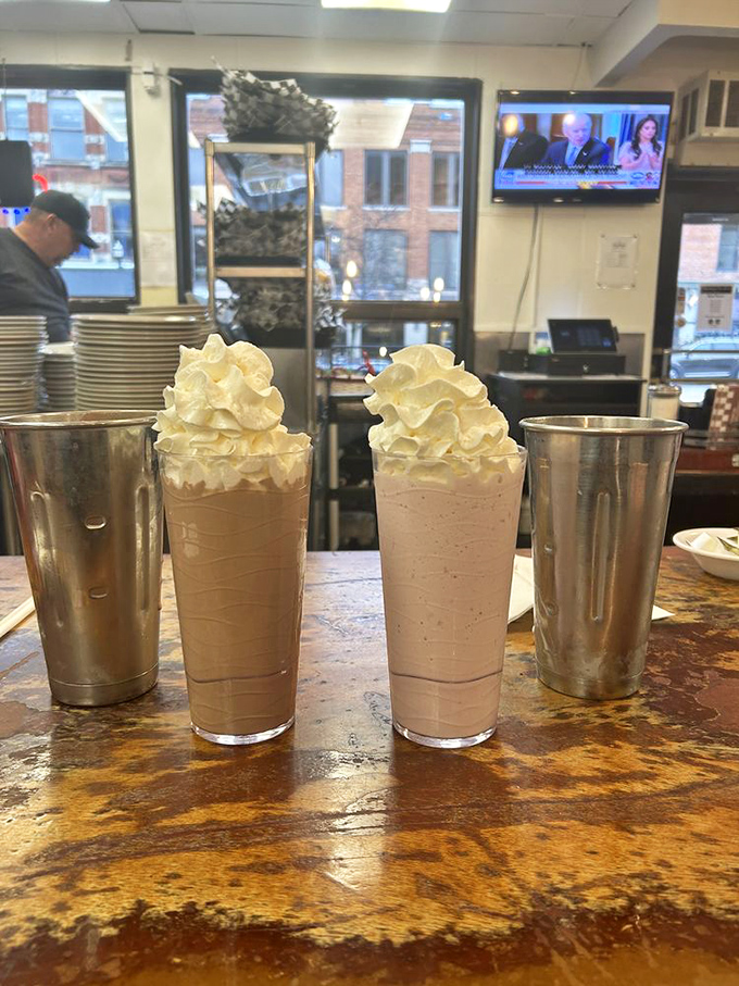Milkshakes thick enough to require serious straw commitment, topped with whipped cream mountains that dare you not to smile.