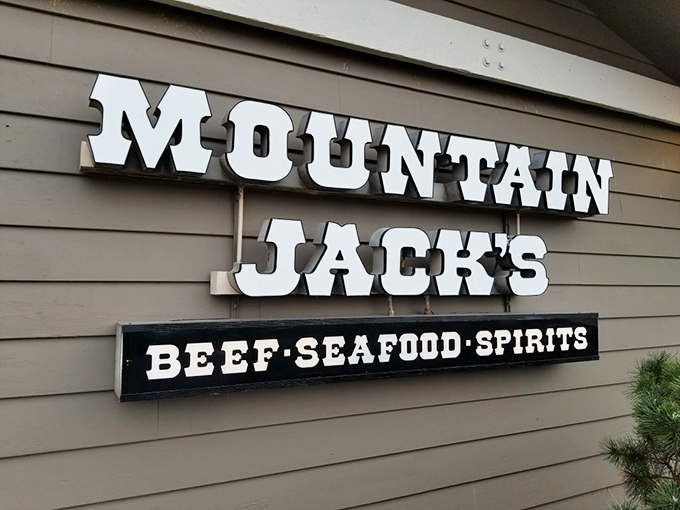 The sign says "BEEF-SEAFOOD-SPIRITS" with the straightforward confidence of someone who knows exactly what you need tonight.