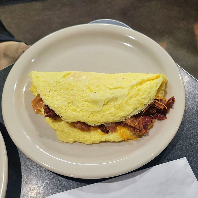 This omelet doesn't just contain bacon&mdash;it celebrates it. Folded yellow perfection housing a smoky, crispy treasure within.