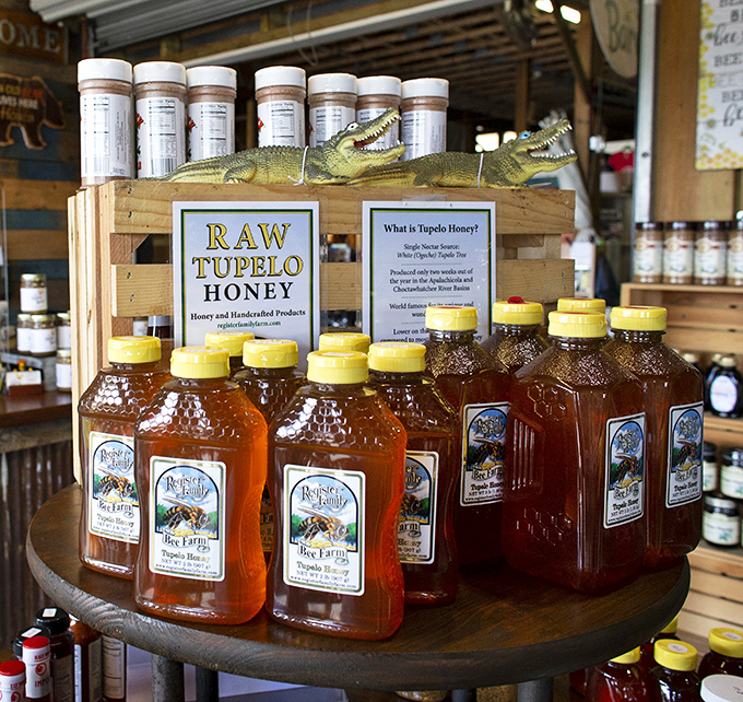 Liquid gold in bottles! Raw tupelo honey gleams under market lights, while alligator guardians remind you this is definitely Florida shopping at its finest.
