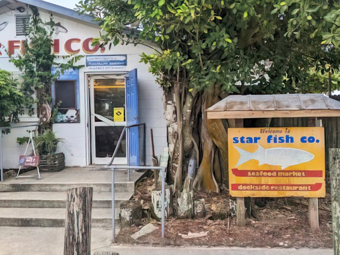 This weathered welcome sign promises adventures in fresh seafood that chain restaurants simply cannot deliver.