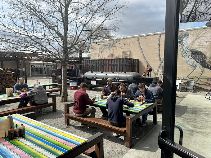 Outdoor dining where picnic tables become conference rooms for the serious business of eating well. Nature's dining room.