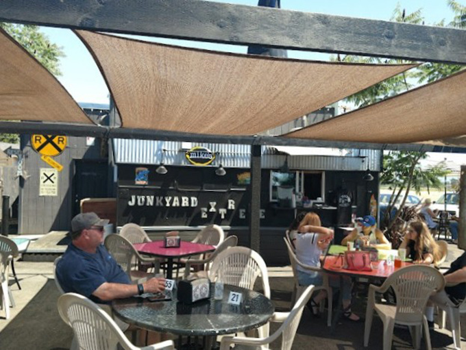 Outdoor dining under canvas sails&mdash;where Junction City sunshine meets culinary adventure in perfect harmony.