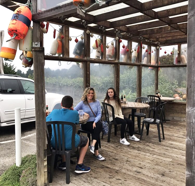 The fog-kissed patio offers al fresco dining with a soundtrack of distant foghorns and the visual poetry of colorful buoys swaying overhead.