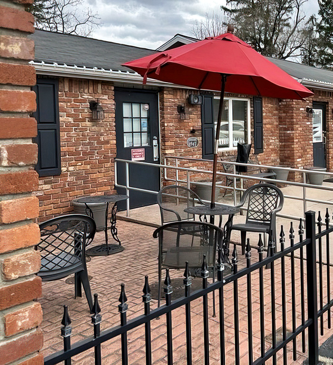 The outdoor seating area, complete with cheerful red umbrella, invites you to savor your pie while watching the world of Laughlintown go by.