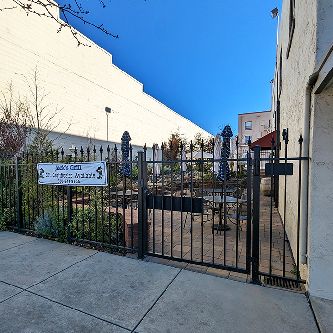 The outdoor patio waits behind wrought iron gates &ndash; a secret garden for those who prefer their steak with a side of fresh air.