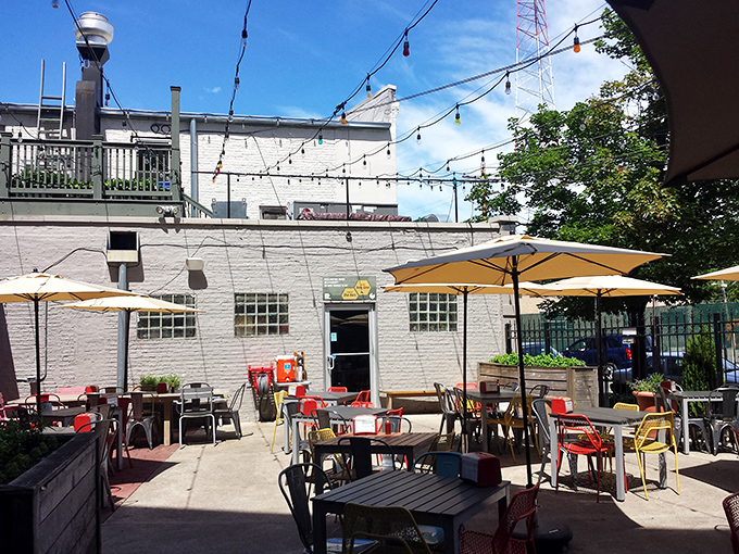 The patio where summer memories are made. String lights await evening, while yellow umbrellas provide daytime shade for outdoor chicken enthusiasts.